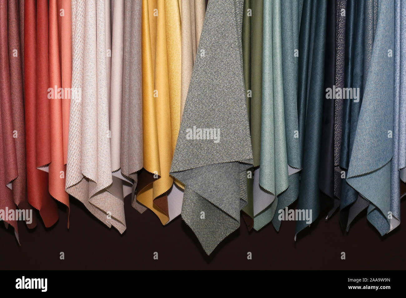 Colorful textile materials samples hanging in fashion factory Stock ...
