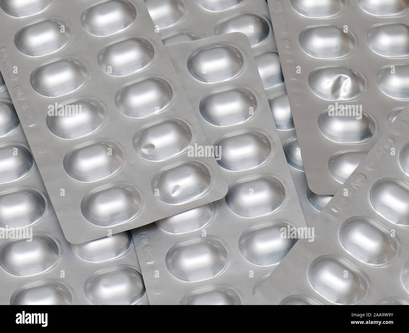 Medicine pills silver blisters pile pattern background Stock Photo - Alamy