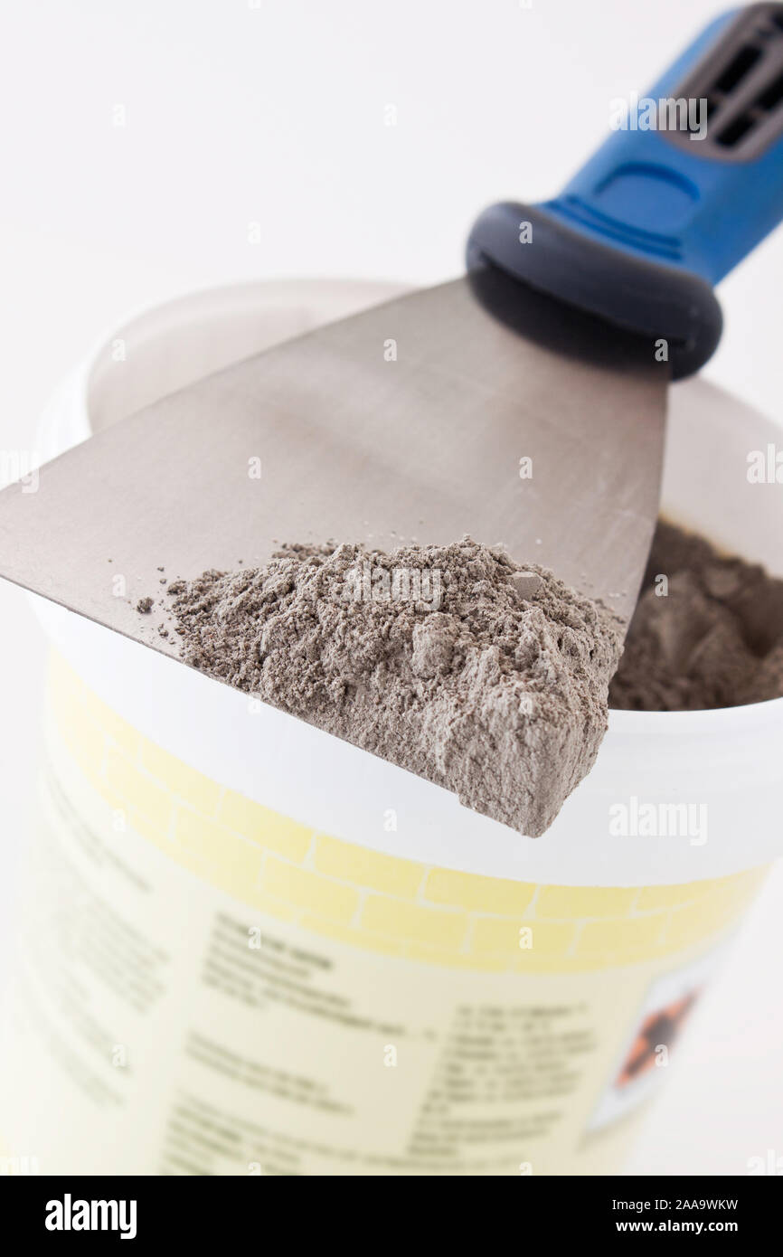 Handcraft cement and putty knife on white background Stock Photo - Alamy