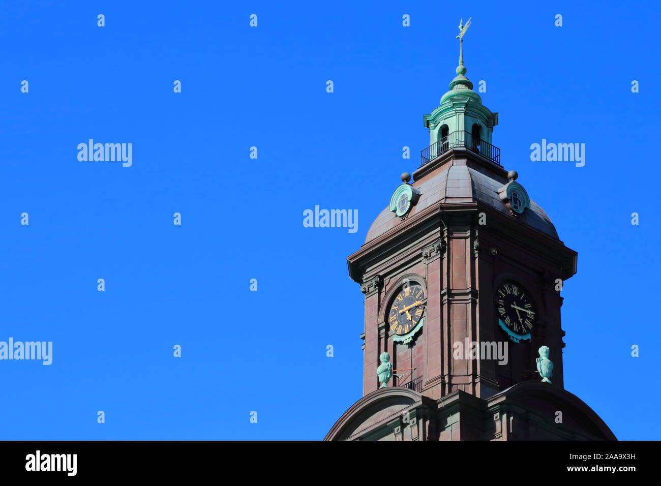 The facade of a clock tower in Gothenburg city, Sweden, against a clear ...