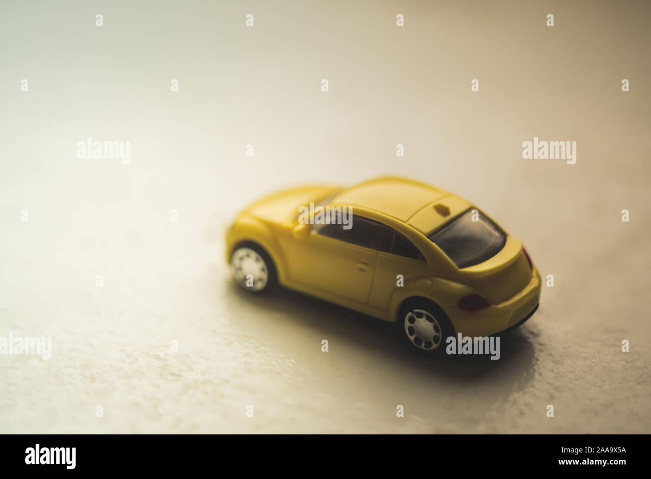 Toy car on the white stone surface with warm light, side view Stock ...