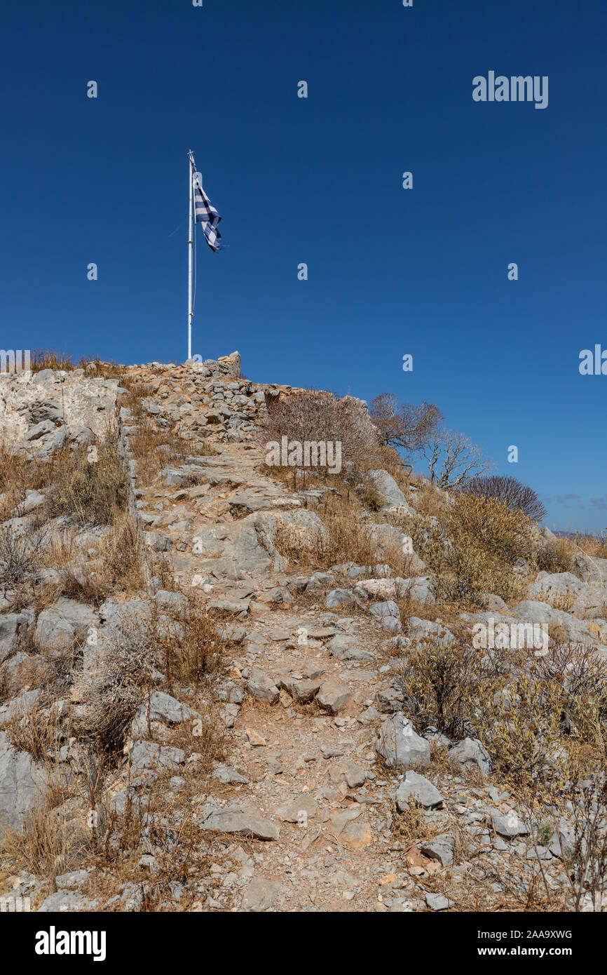 Greek flag and ruins over a mountain in Hydra Island, Greece Stock ...