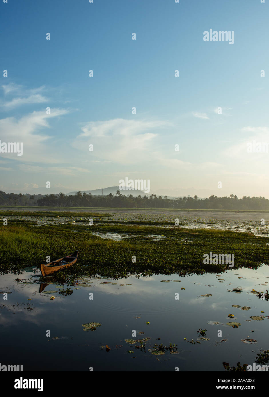 Vellayani Lake at Sunrise with a faint view of Agasthyakoodam peak at ...