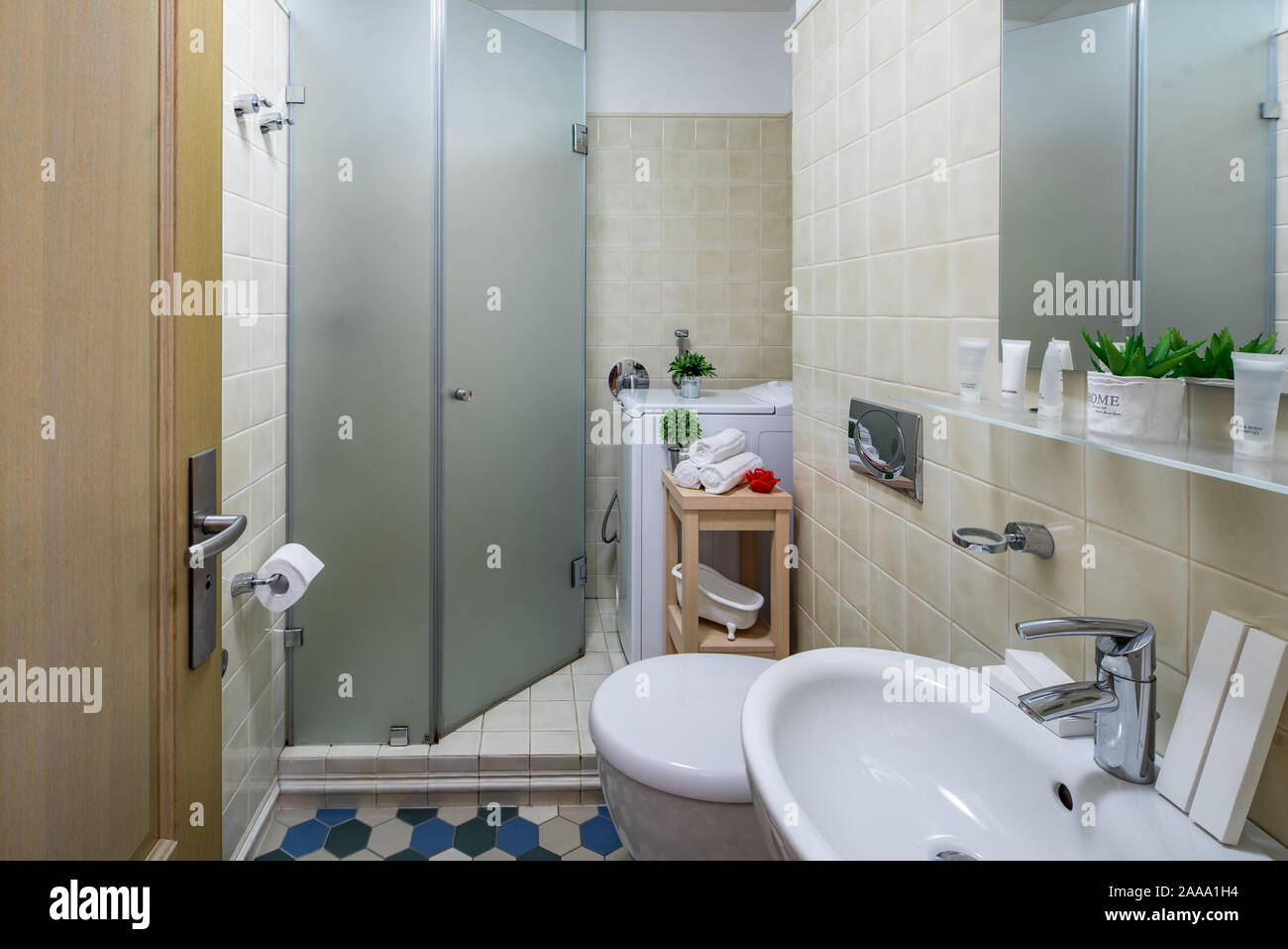 Bathroom with shower cabin. Tile floor and walls Stock Photo - Alamy