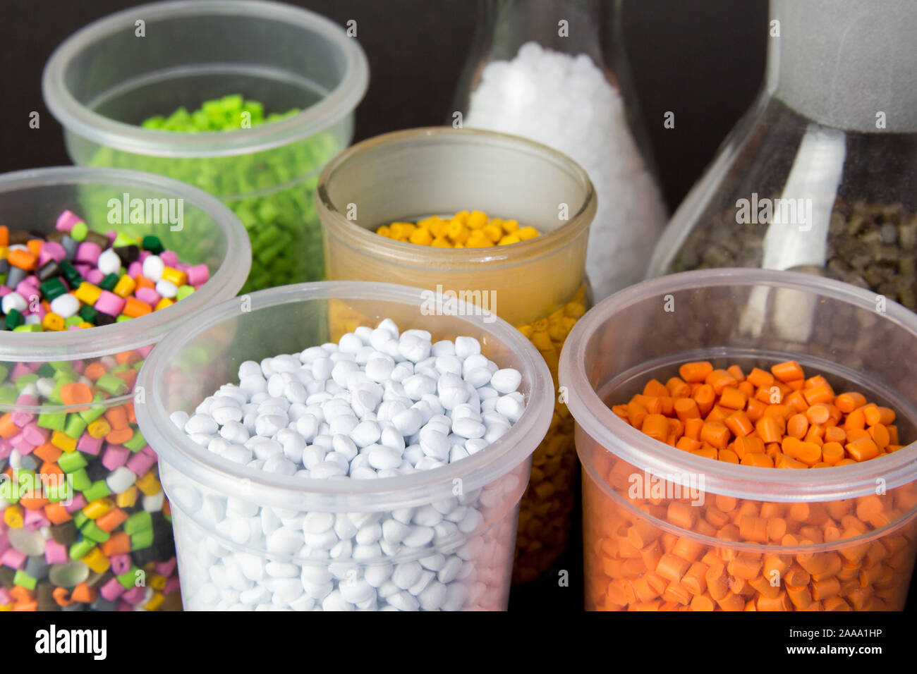 Plastic granules in a measuring container and test tubes in the ...