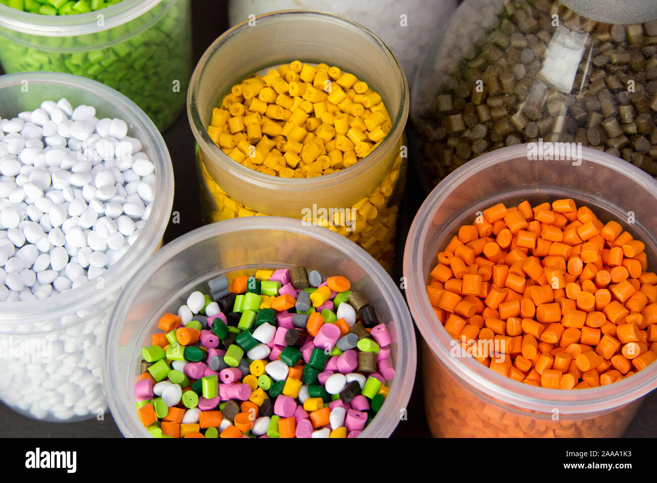 Plastic granules in a measuring container and test tubes in the ...