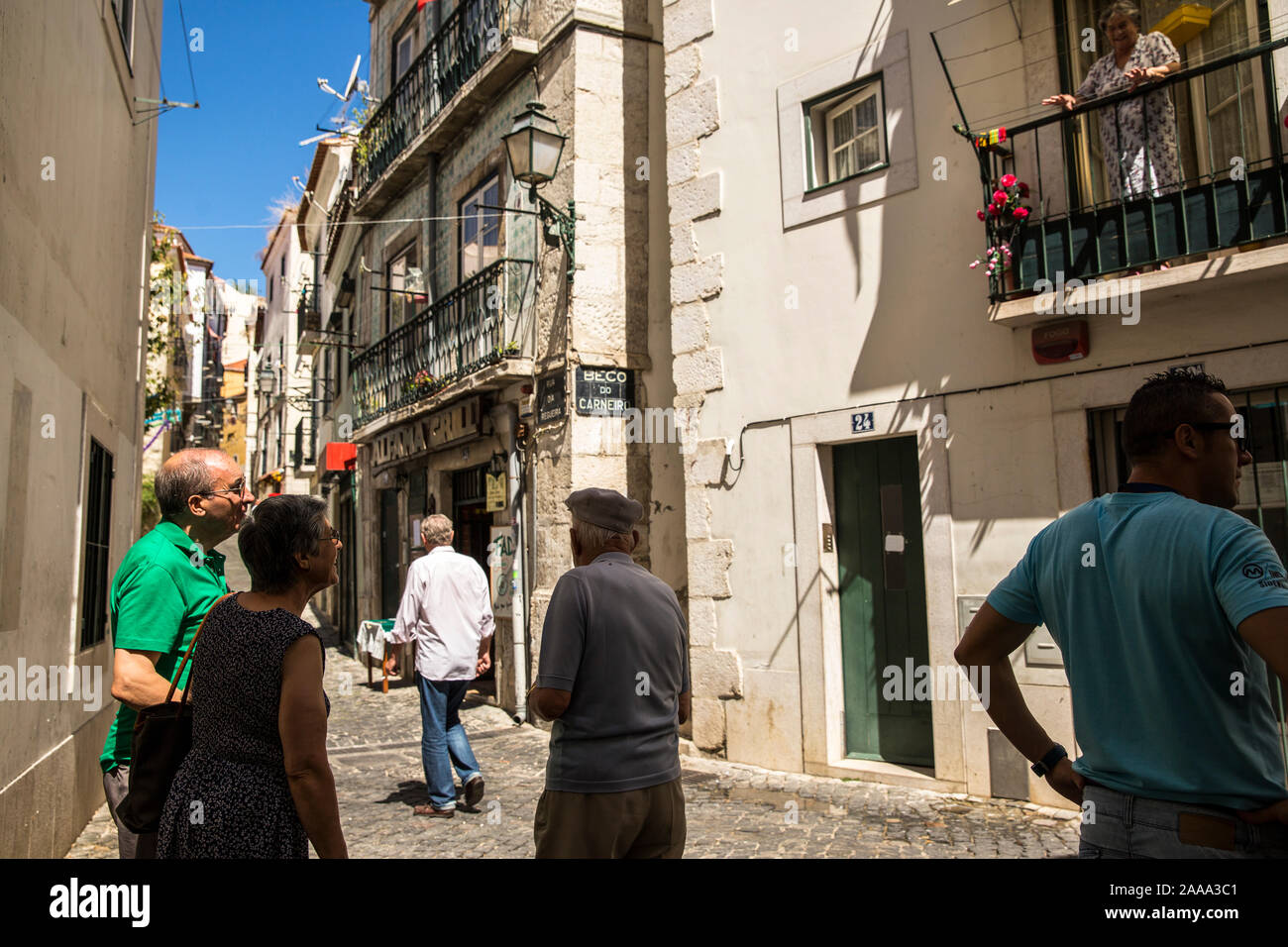 People talking on the street in Alfama. Lisbon, Portugal Stock Photo ...
