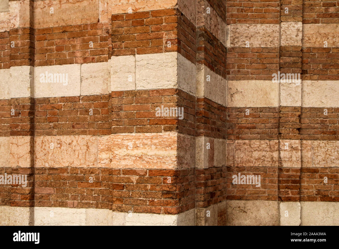A detail of the facade of the italian roman church made of bricks with ...