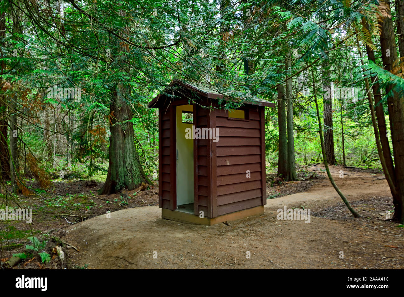 An outdoor outhouse on a hiking trail in the forest on Vancouver Island ...