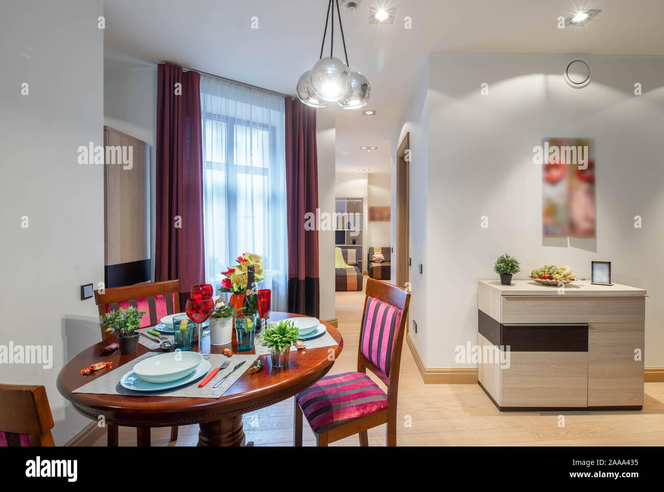 Modern interior of studio apartment. Set table. Wooden furniture Stock ...