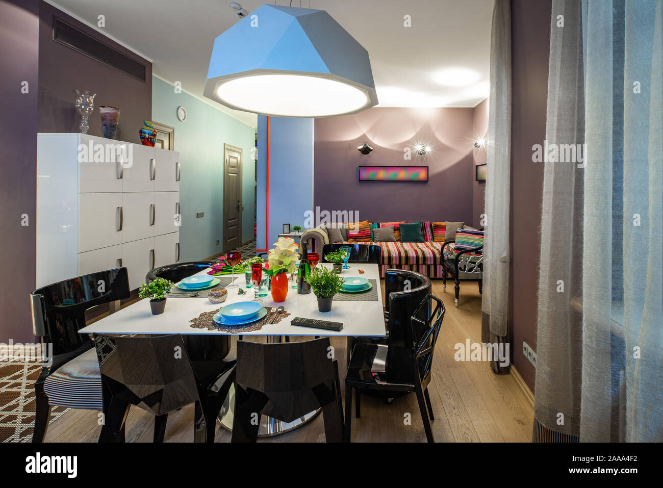 Modern interior of studio apartment. Set table. Living room and kitchen ...