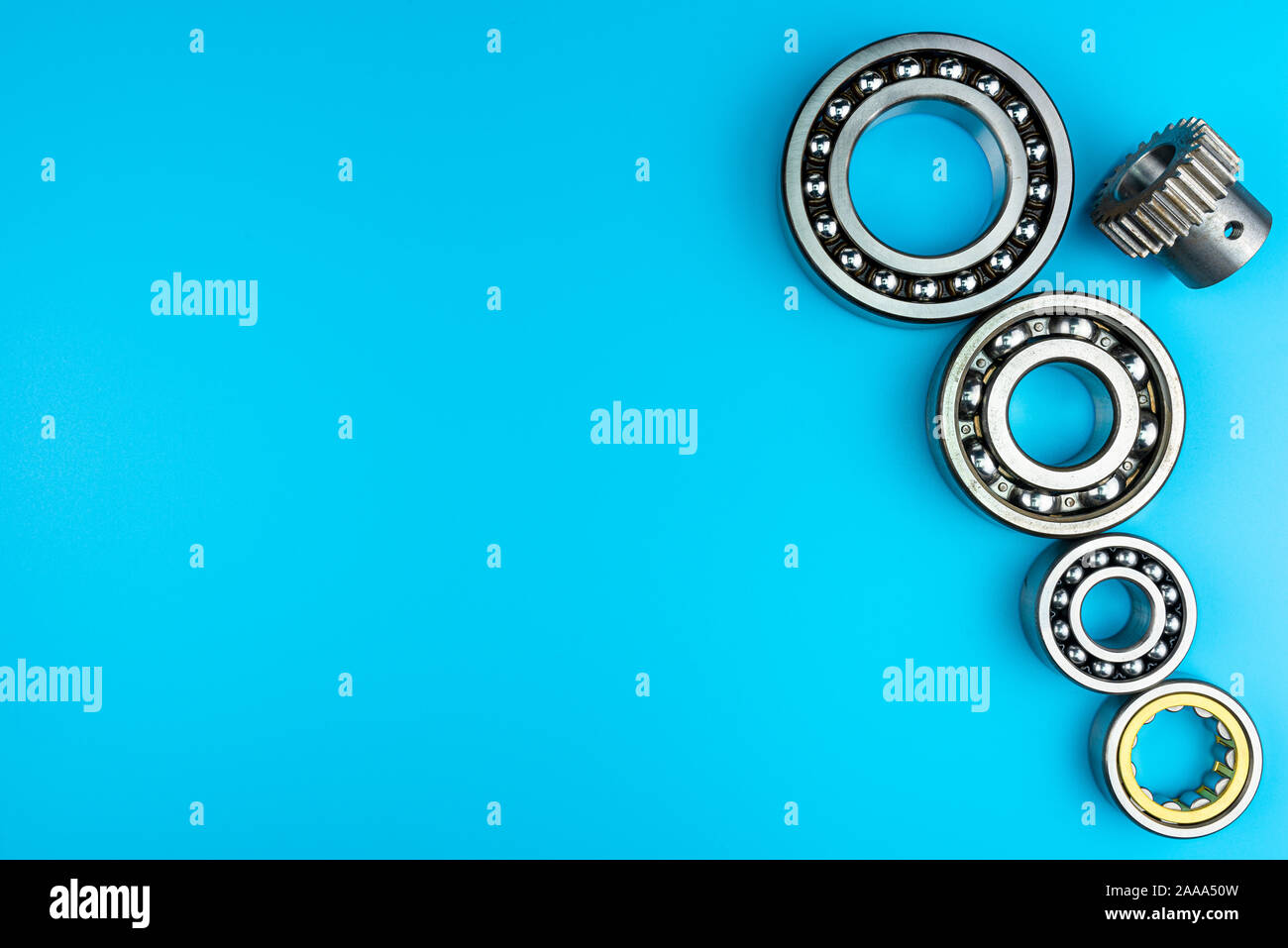 Ball bearing lying on a blue background with copy space on the left ...
