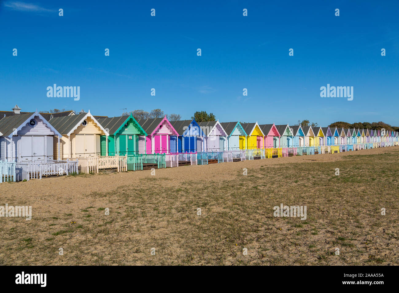 A row of pastel coloured beach huts at West Mersea. Mersea Island ...