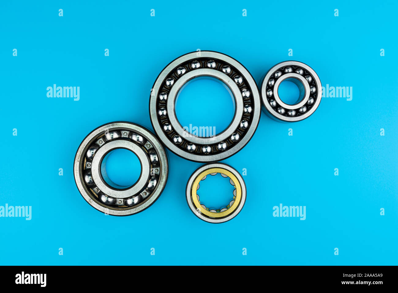 Ball bearing lying on a blue background with copy space on the sides ...