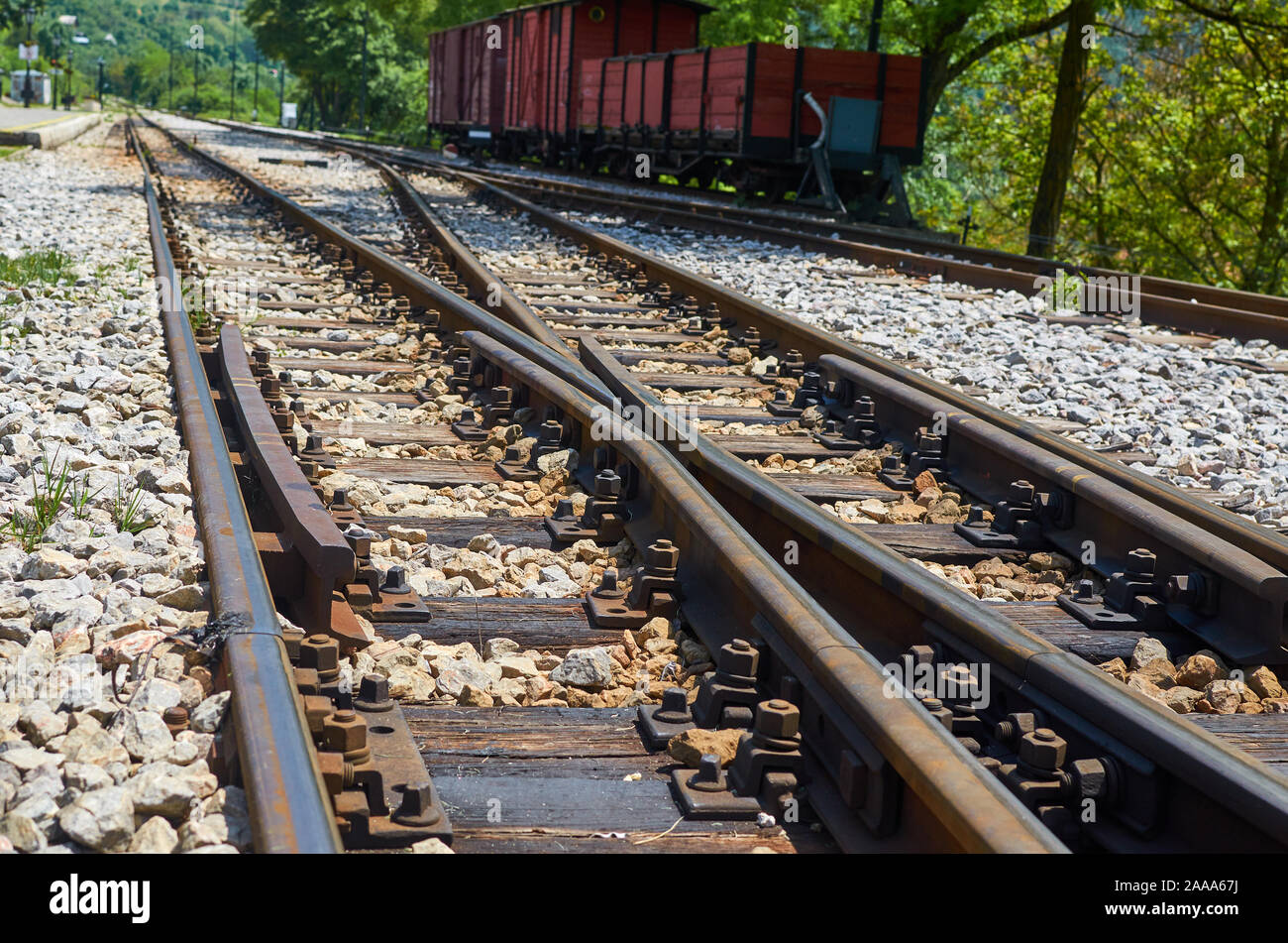 Railway tracks with wagons on one track Stock Photo - Alamy