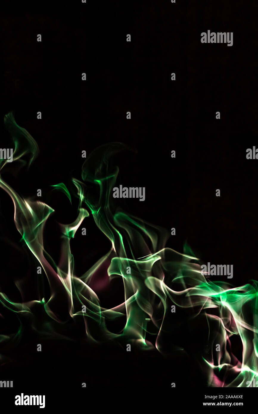 Green fire forms abstraction in black background Stock Photo - Alamy