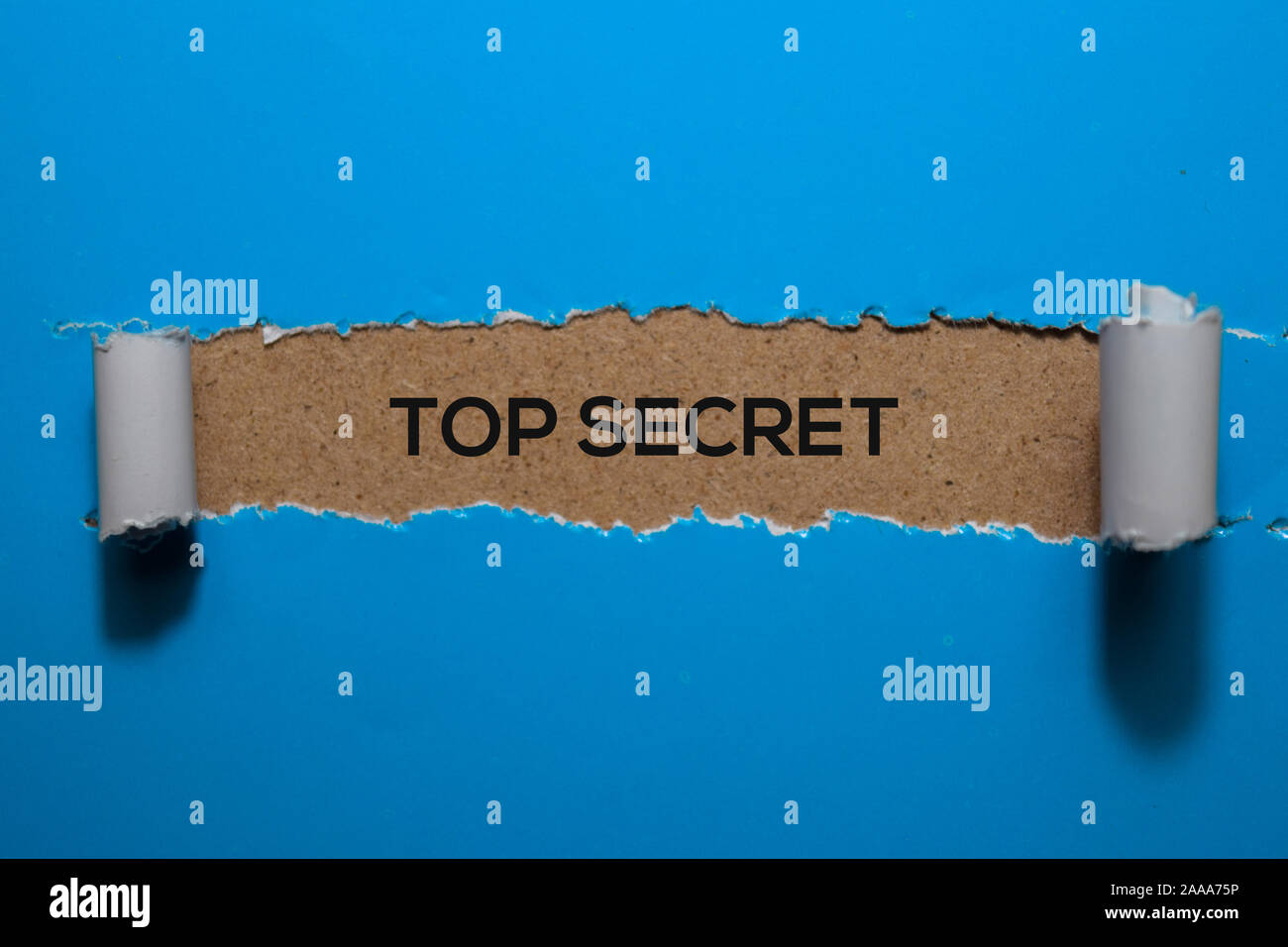 Top Secret write on blue torn paper Stock Photo - Alamy