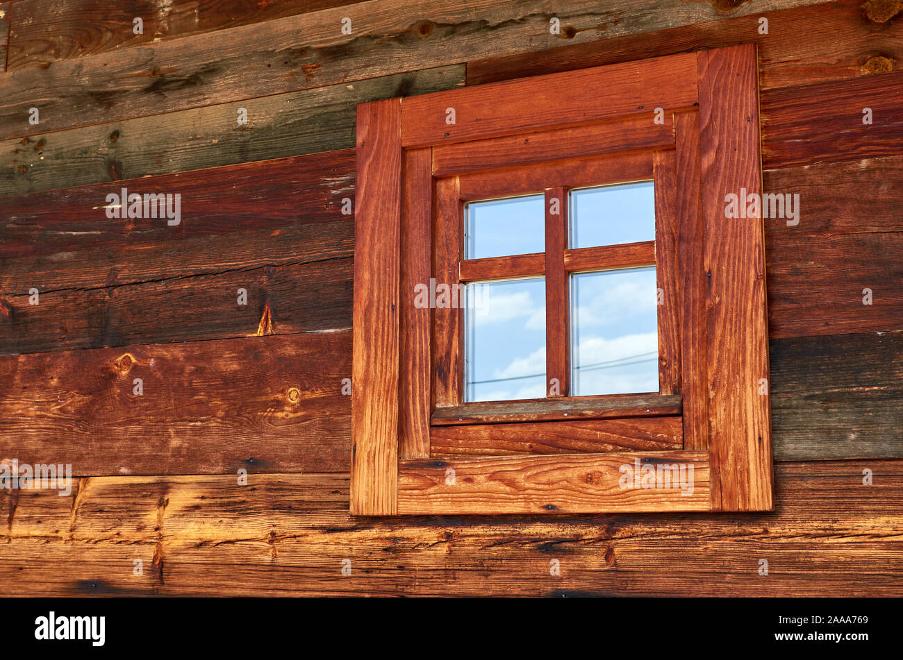 Small window of a wooden cottage in a traditional village style Stock ...
