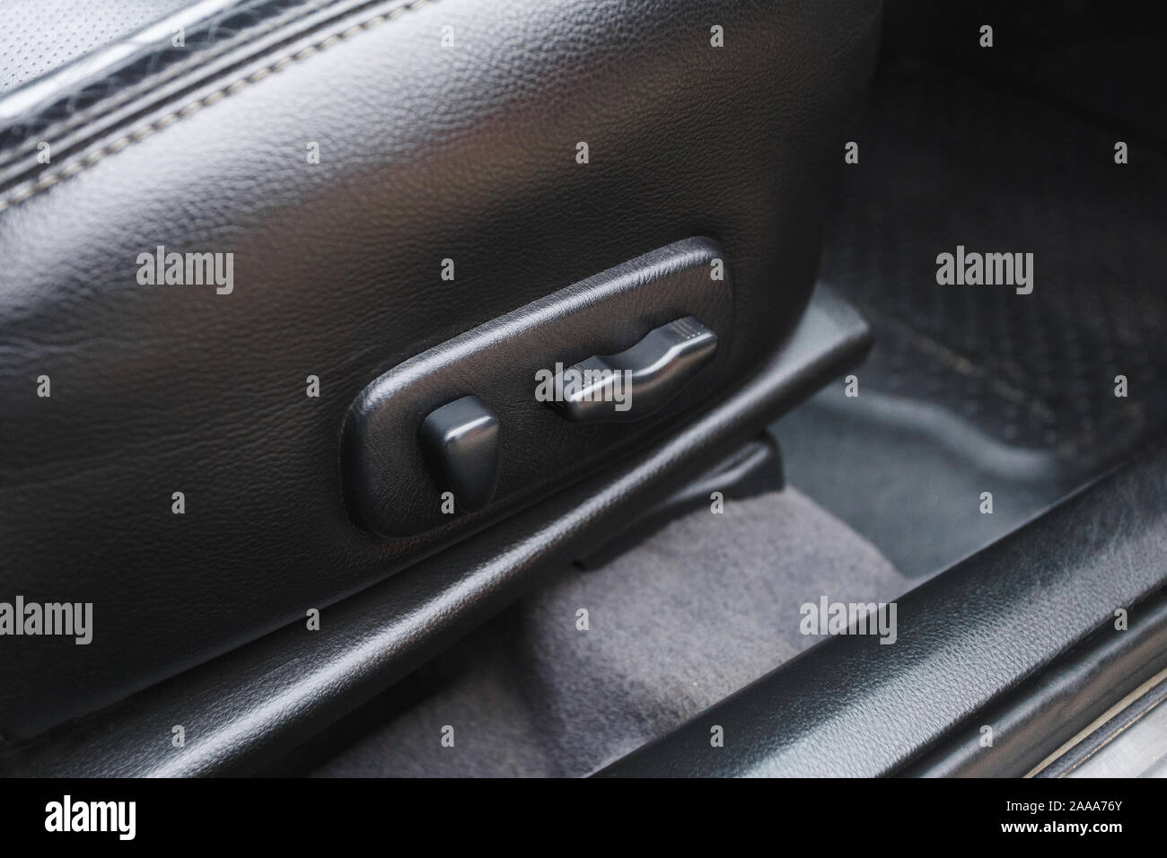 Arm adjusting the seat position in the car Stock Photo - Alamy