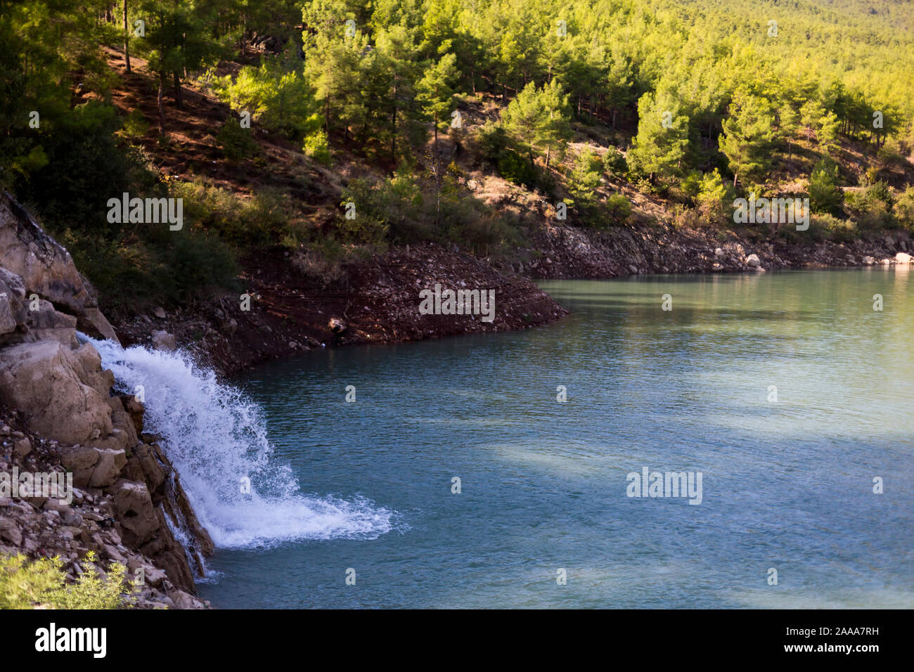 as the water source from the mountain spills into the lake Stock Photo ...