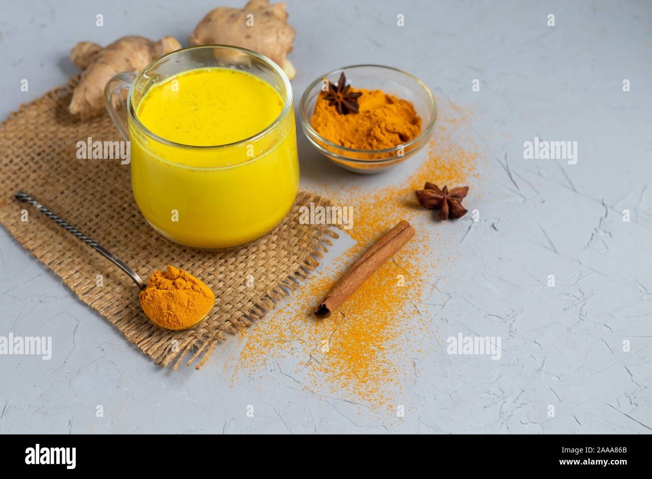 Golden milk with spices. Turmeric, cloves, black pepper and a drop of ...
