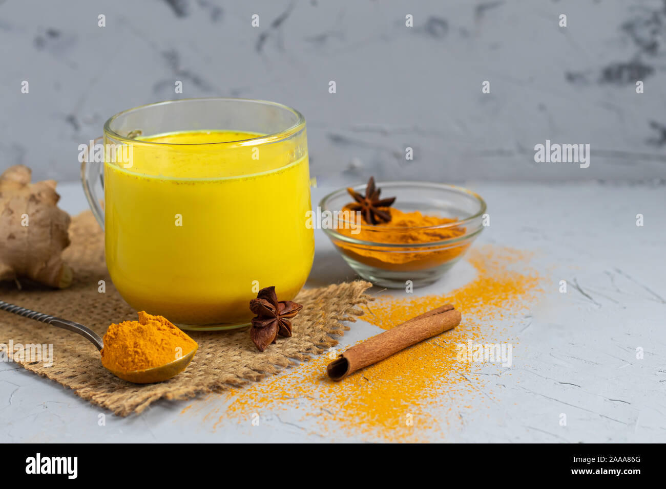 Golden milk with spices. Turmeric, cloves, black pepper and a drop of ...