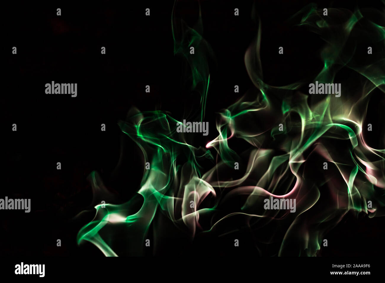 Green fire forms abstraction in black background Stock Photo - Alamy