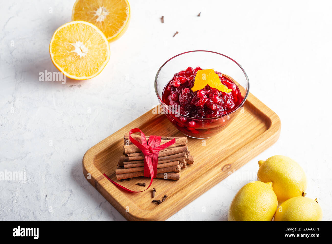 Thanksgiving cranberry sauce in glass bowl with fresh orange fruit and ...