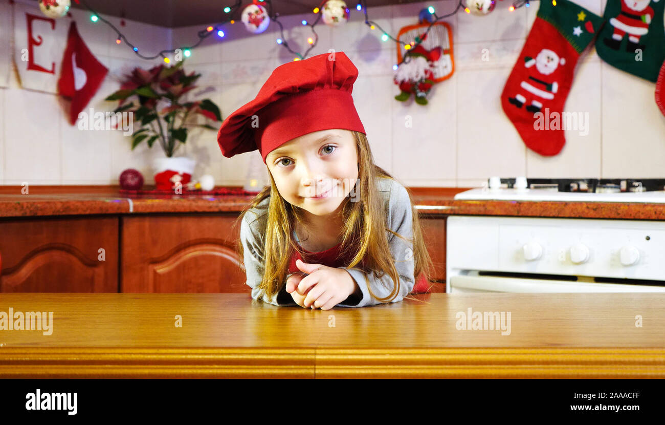 Portrait of cute little girl chef in the christmas kitchen Stock Photo ...