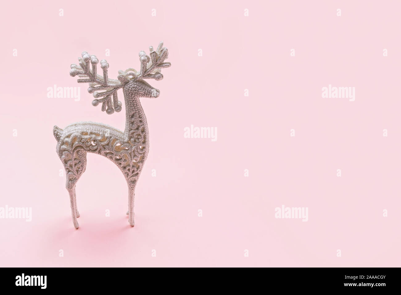 White christmas deer decoration on pastel pink background. Christmas ...