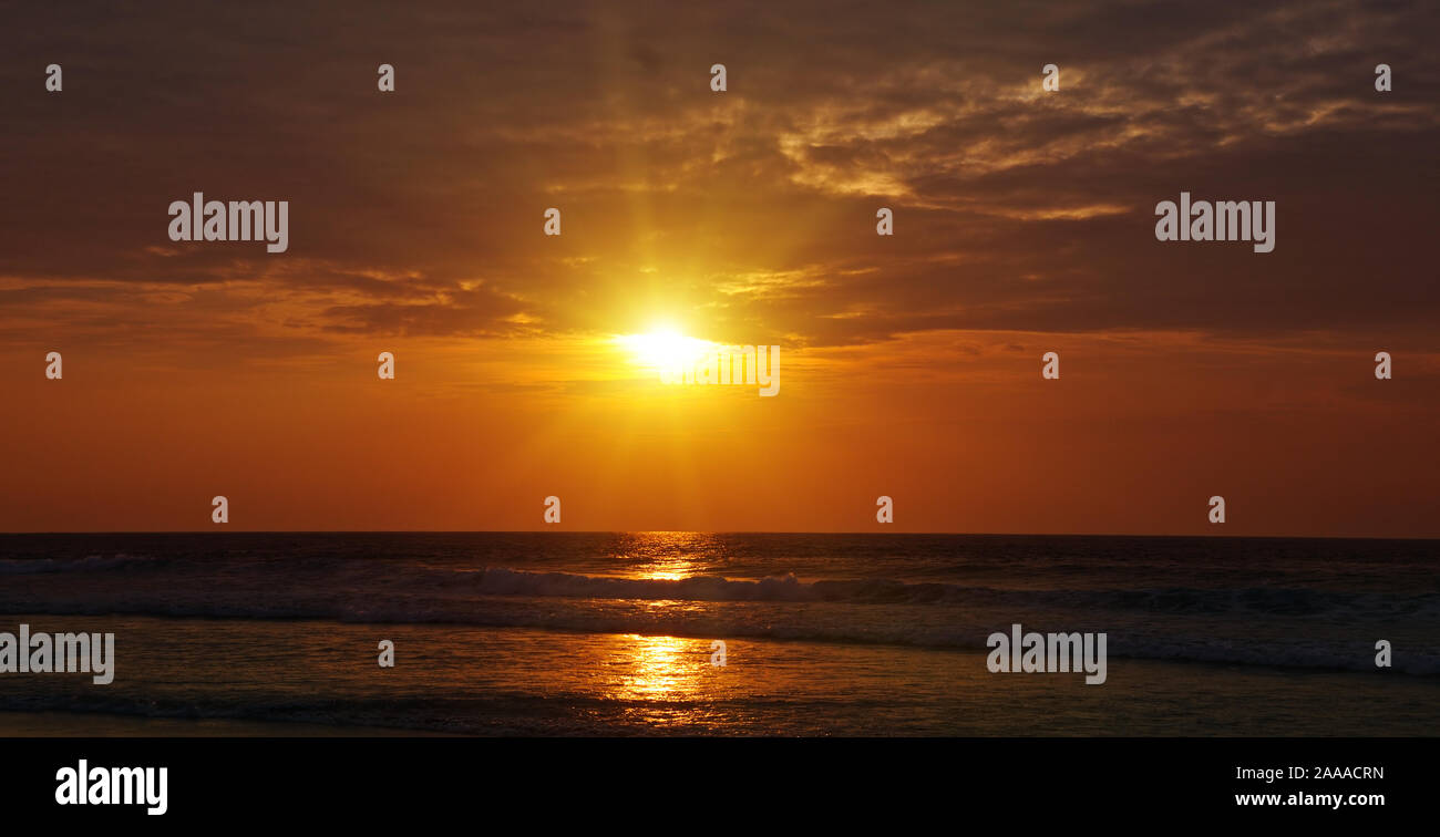 Bright sunrise over the ocean Stock Photo - Alamy