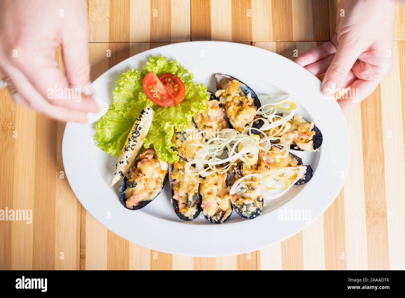 Baked mussels in half shell with filling and side dish Stock Photo - Alamy