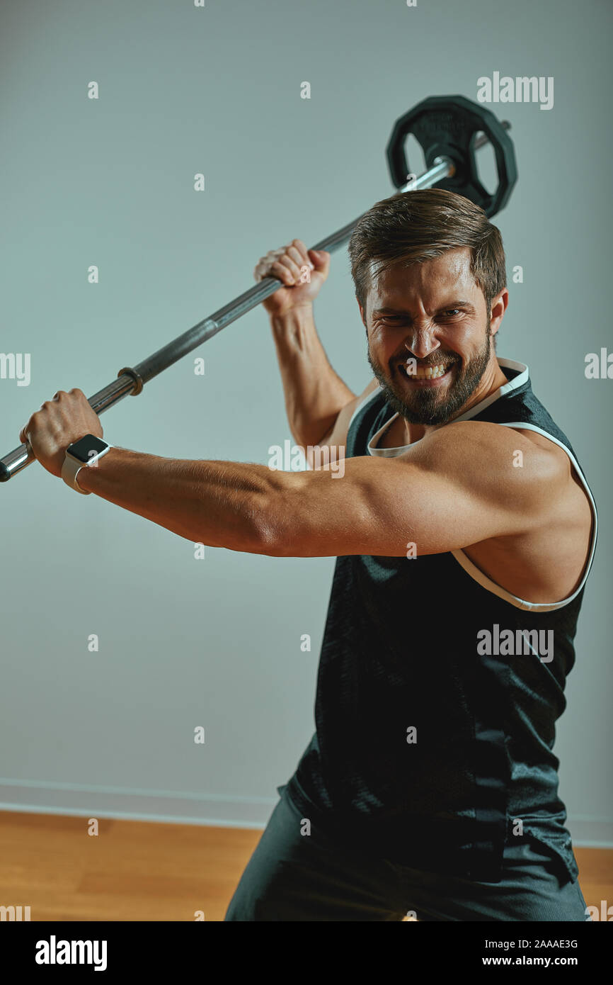 man sportsman weightlifting. Muscular man attacks with barbell Stock ...