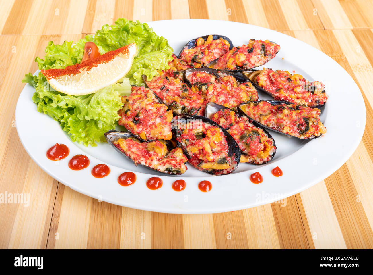 Baked mussels in half shell with filling and side dish Stock Photo - Alamy