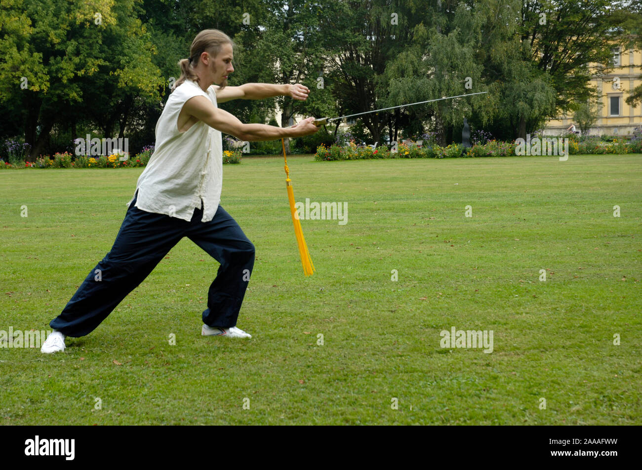 Man doing Tai Chi in park, Bad Kissingen, Germany / Mann bei Tai Chi ...
