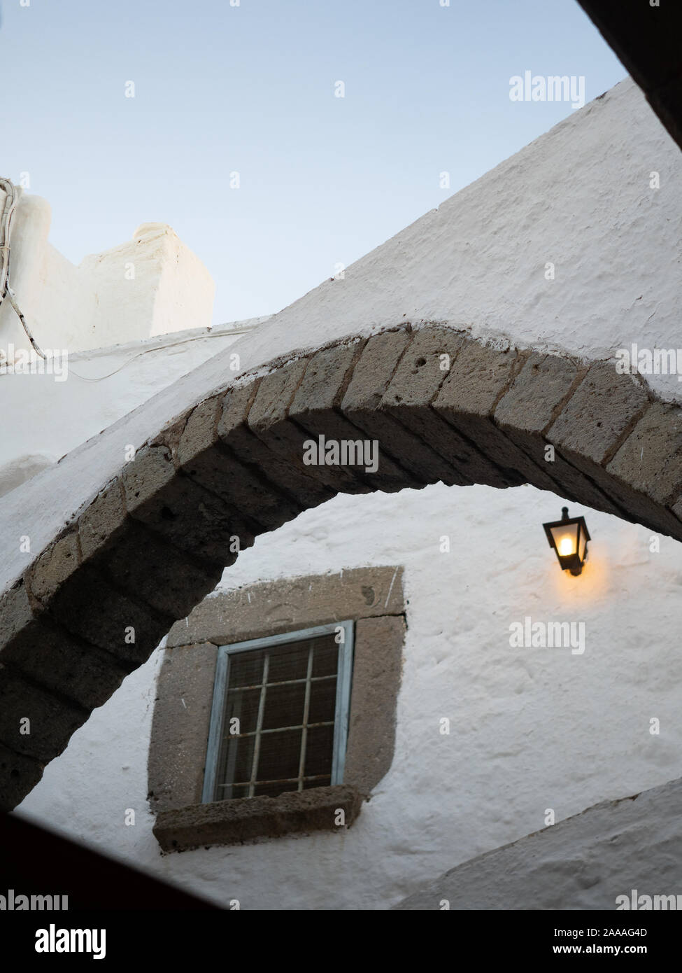 Close up of the masonry arch and white stucco walls of the Greek ...