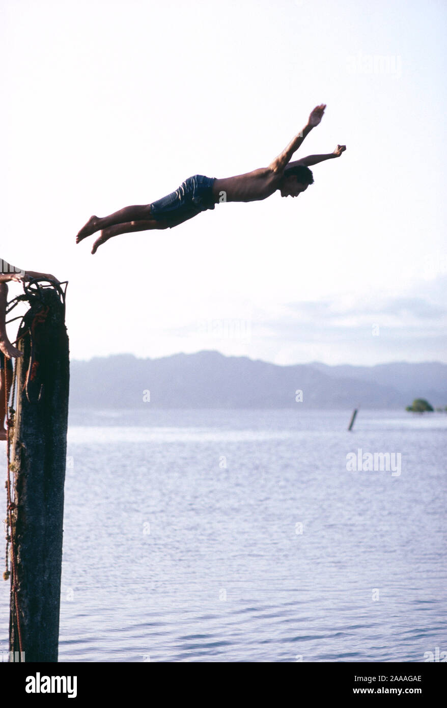 Fiji. Young man diving into sea from wharf Stock Photo - Alamy