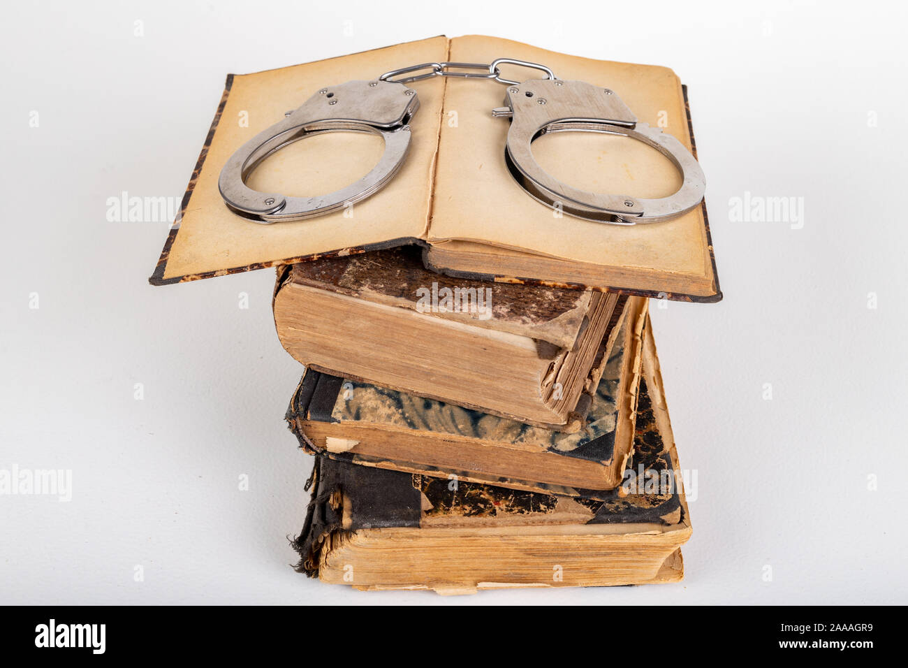 Old books and metal handcuffs. Literature and prison for bad words ...