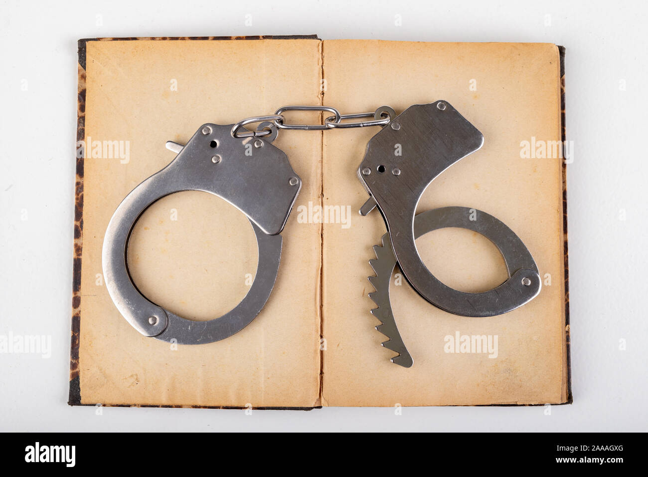 Old books and metal handcuffs. Literature and prison for bad words ...