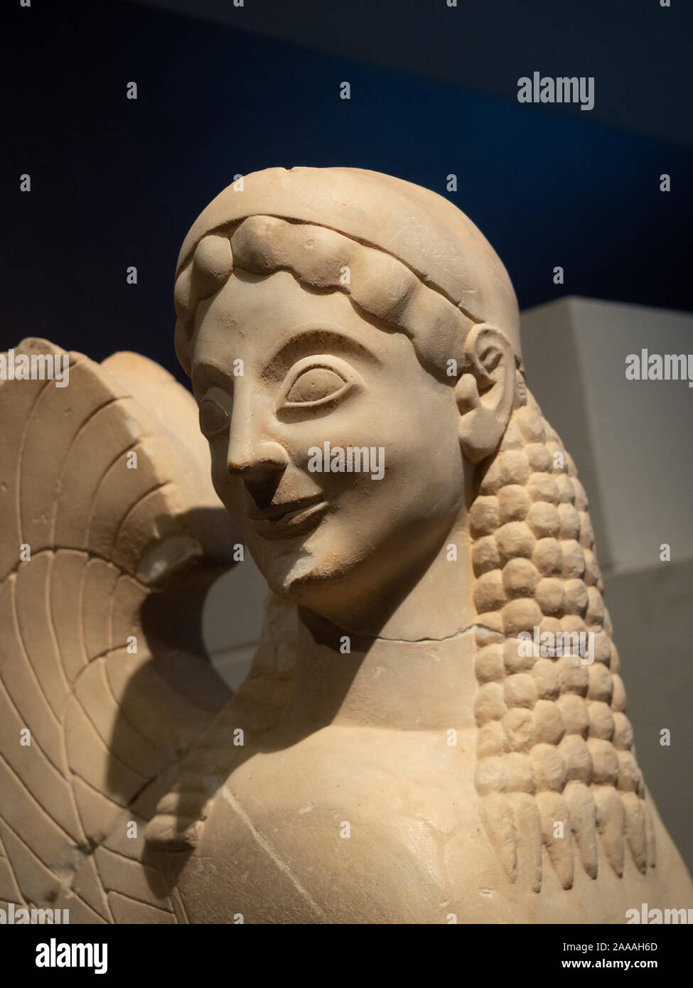Close up of the carved human head with long hair and slight smile atop ...