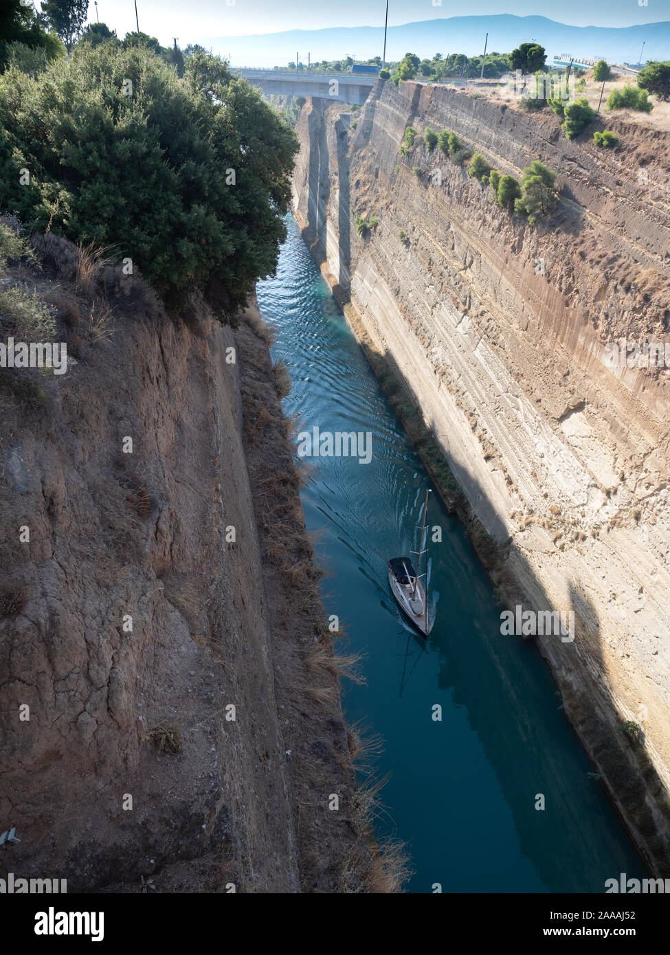 A sleek yacht sailing through the Corinth Canal in the Isthmus of ...