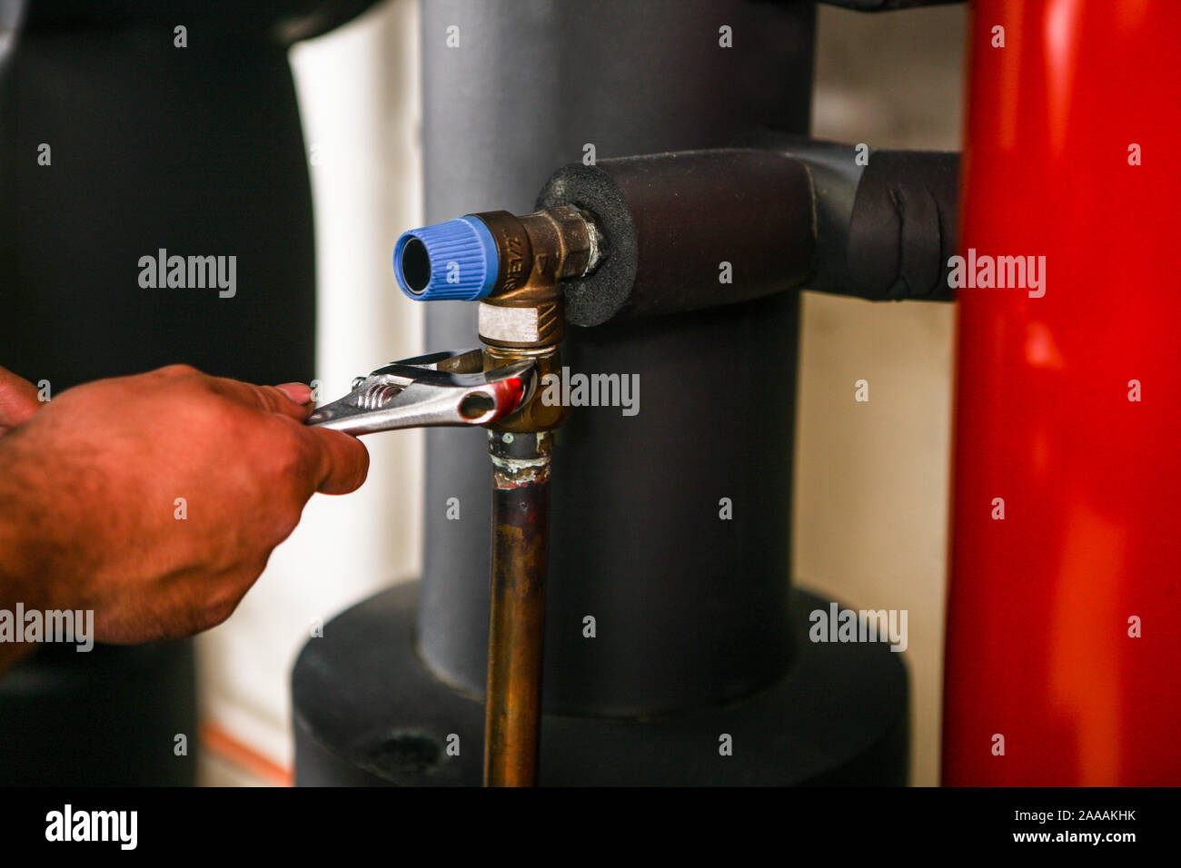man fixing a pipe with a wrench Stock Photo - Alamy