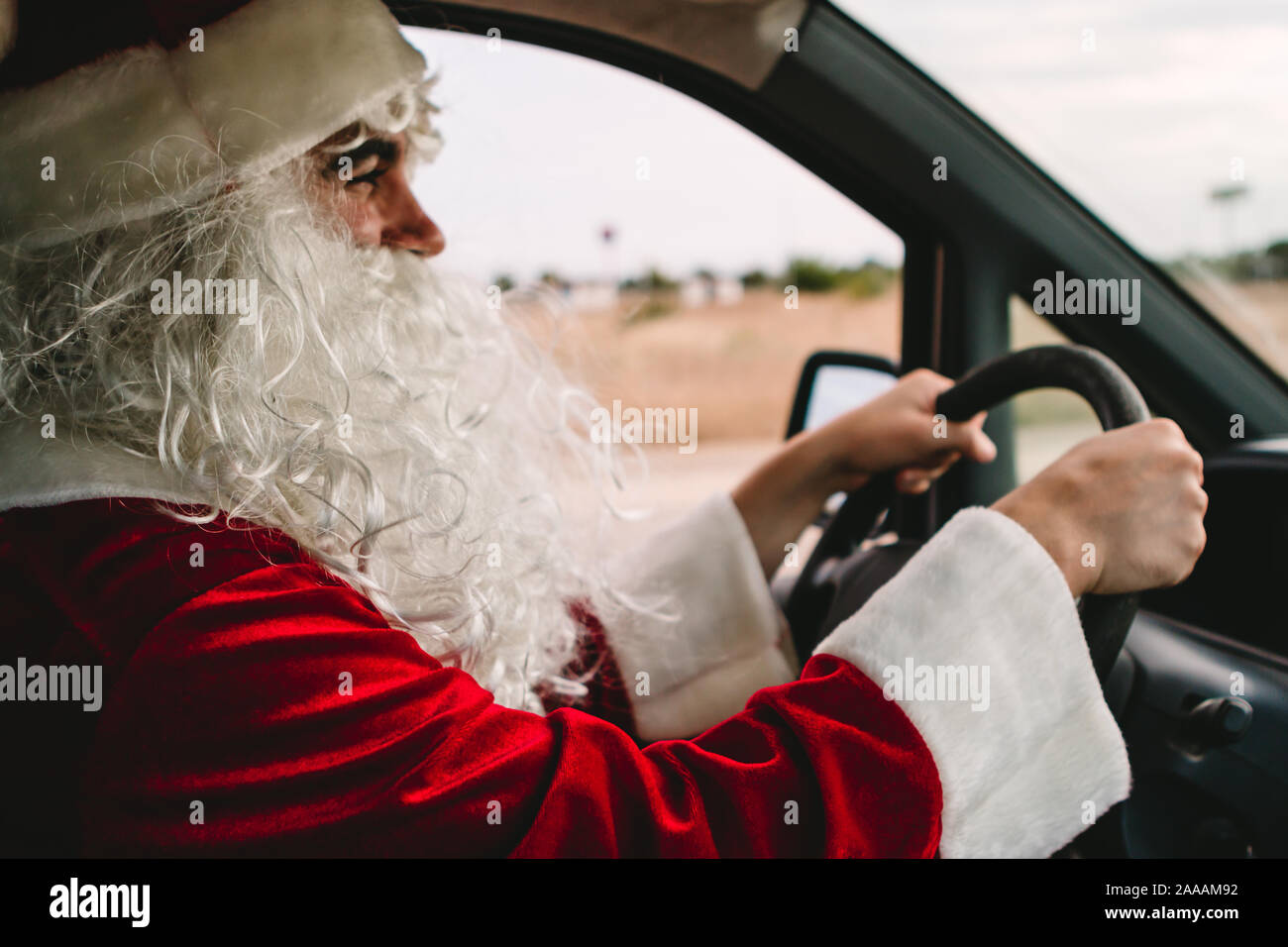 Santa Claus working as a delivery man while driving a van Stock Photo ...