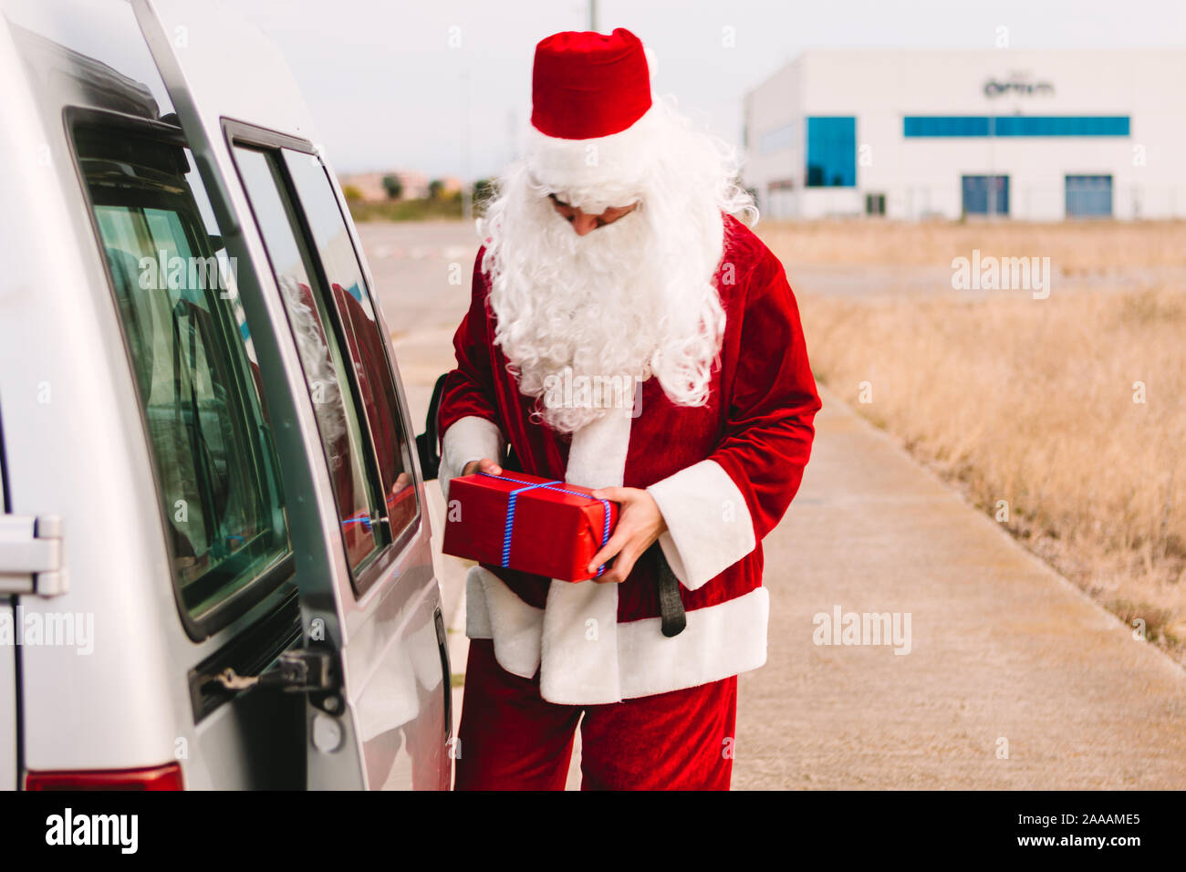 Santa Claus working as a delivery man at christmas Stock Photo - Alamy