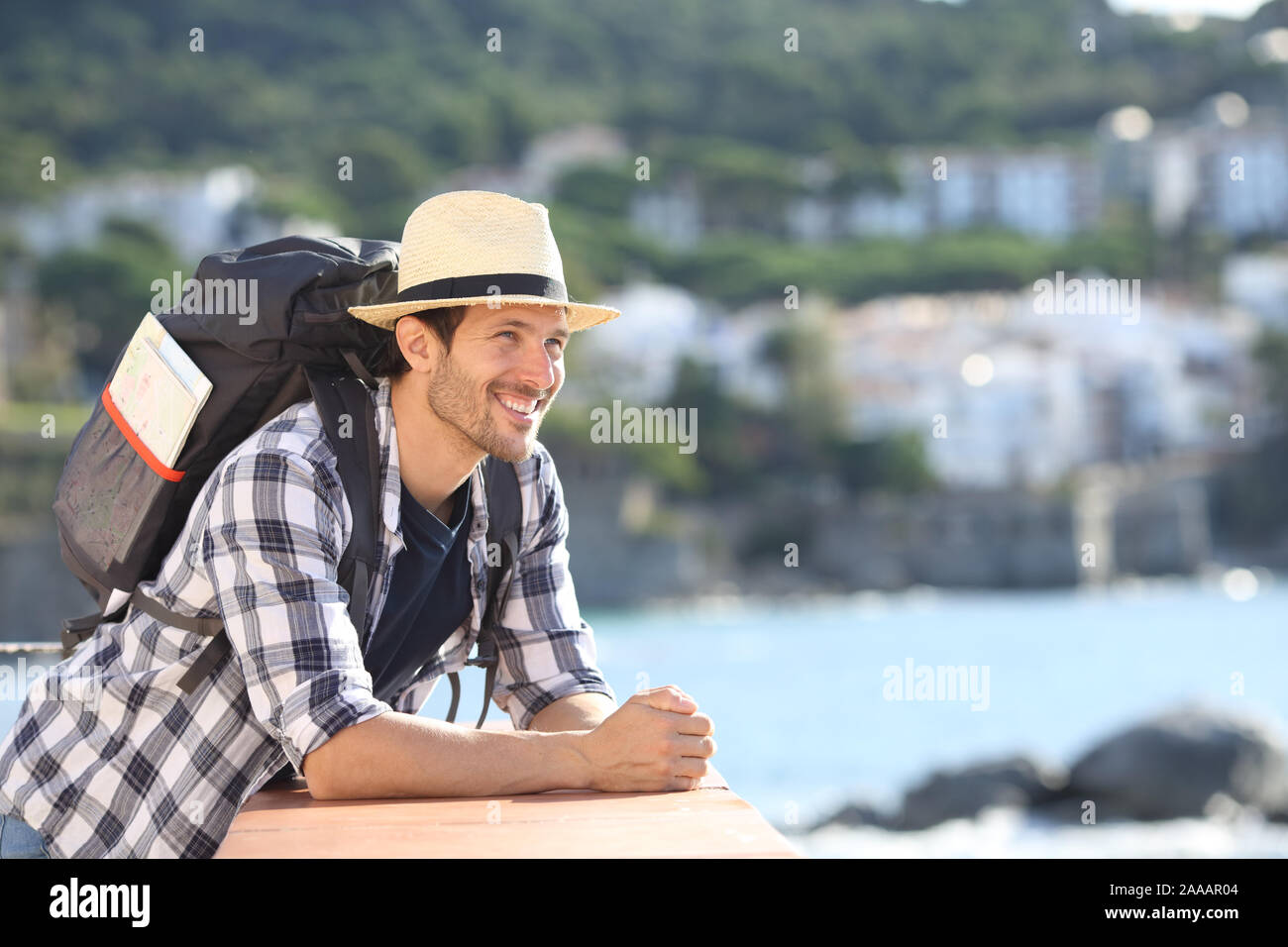 Happy tourist sightseeing from a balcony traveling on summer vacation ...