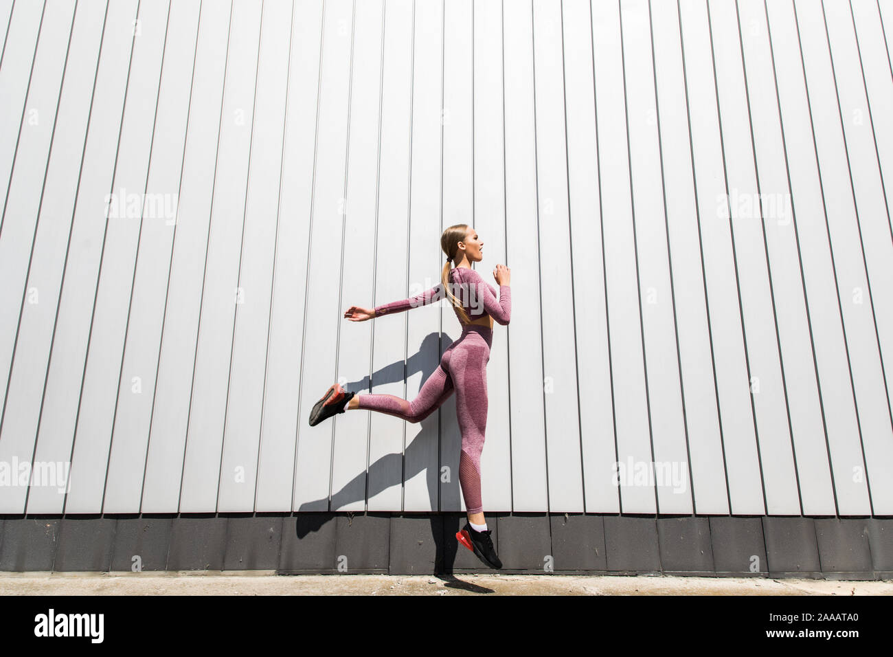 Female athlete jumping stretching hi-res stock photography and images ...