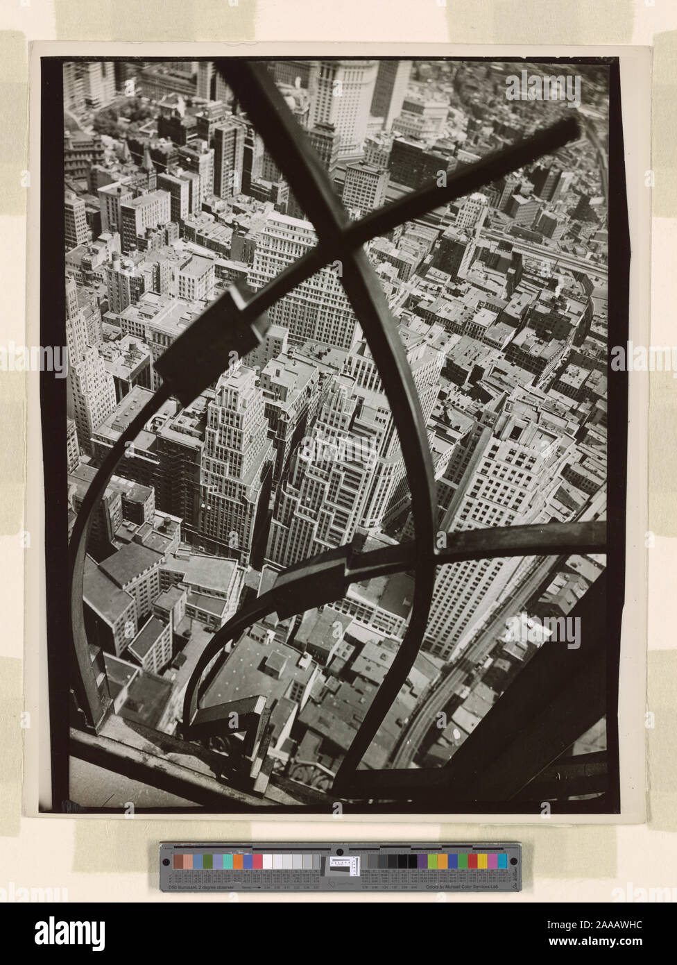 Looking through railings at roof's edge on buildings below. Citation ...
