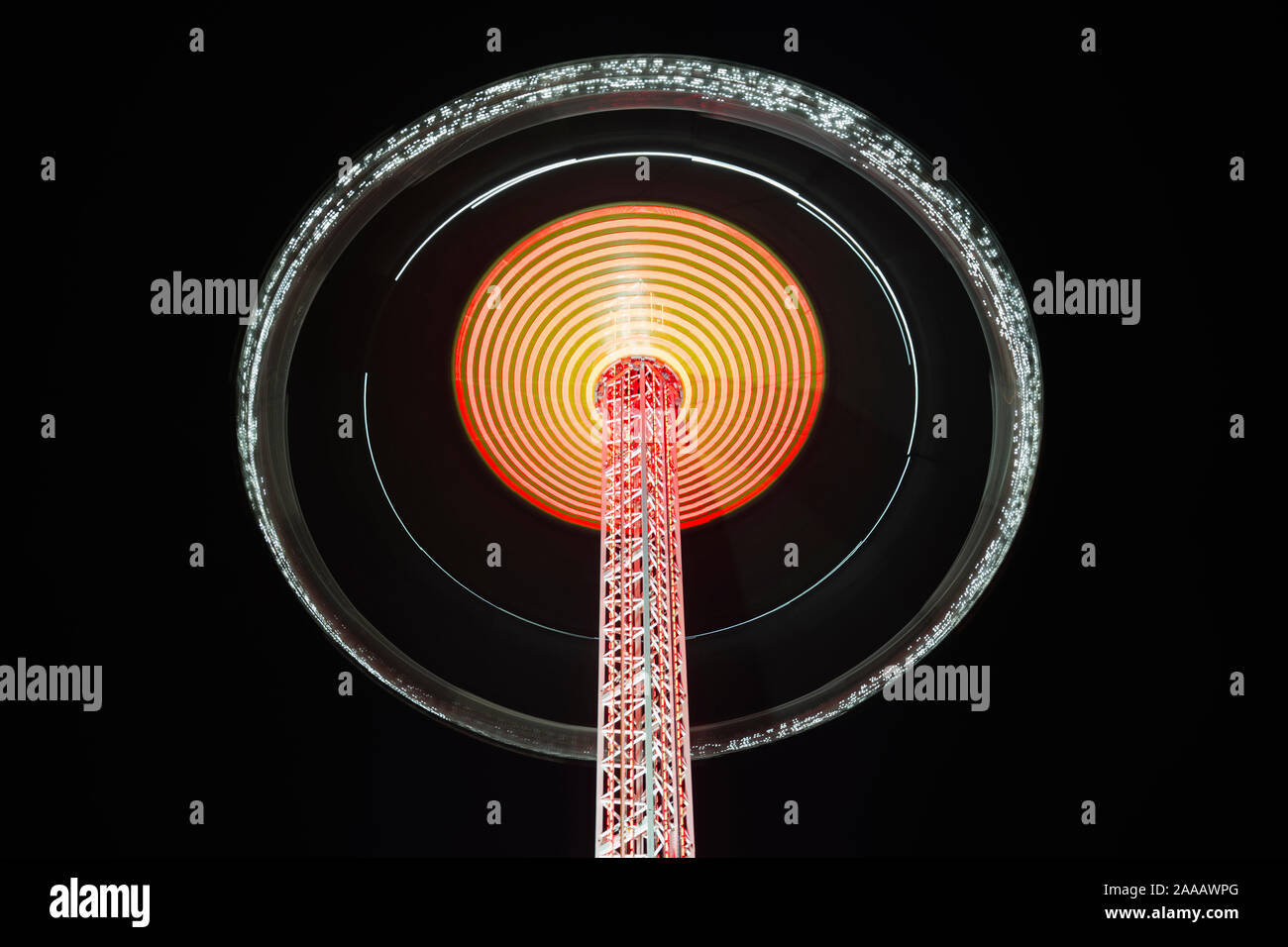 A tall spinning amusement ride at Southbank Christmas market in London ...