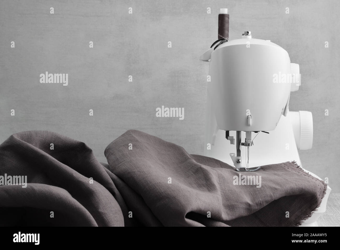 Sewing linen clothes on a sewing machine Stock Photo - Alamy