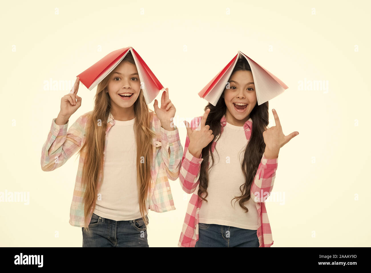 Knowledge is power. Adorable little school girls holding books over ...